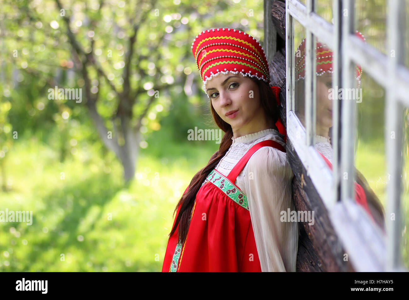 Slav woman in traditional dress wooden wall Stock Photo - Alamy