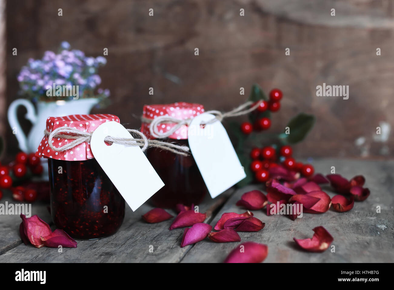 rustic homemade jam jar wooden background and flower Stock Photo - Alamy