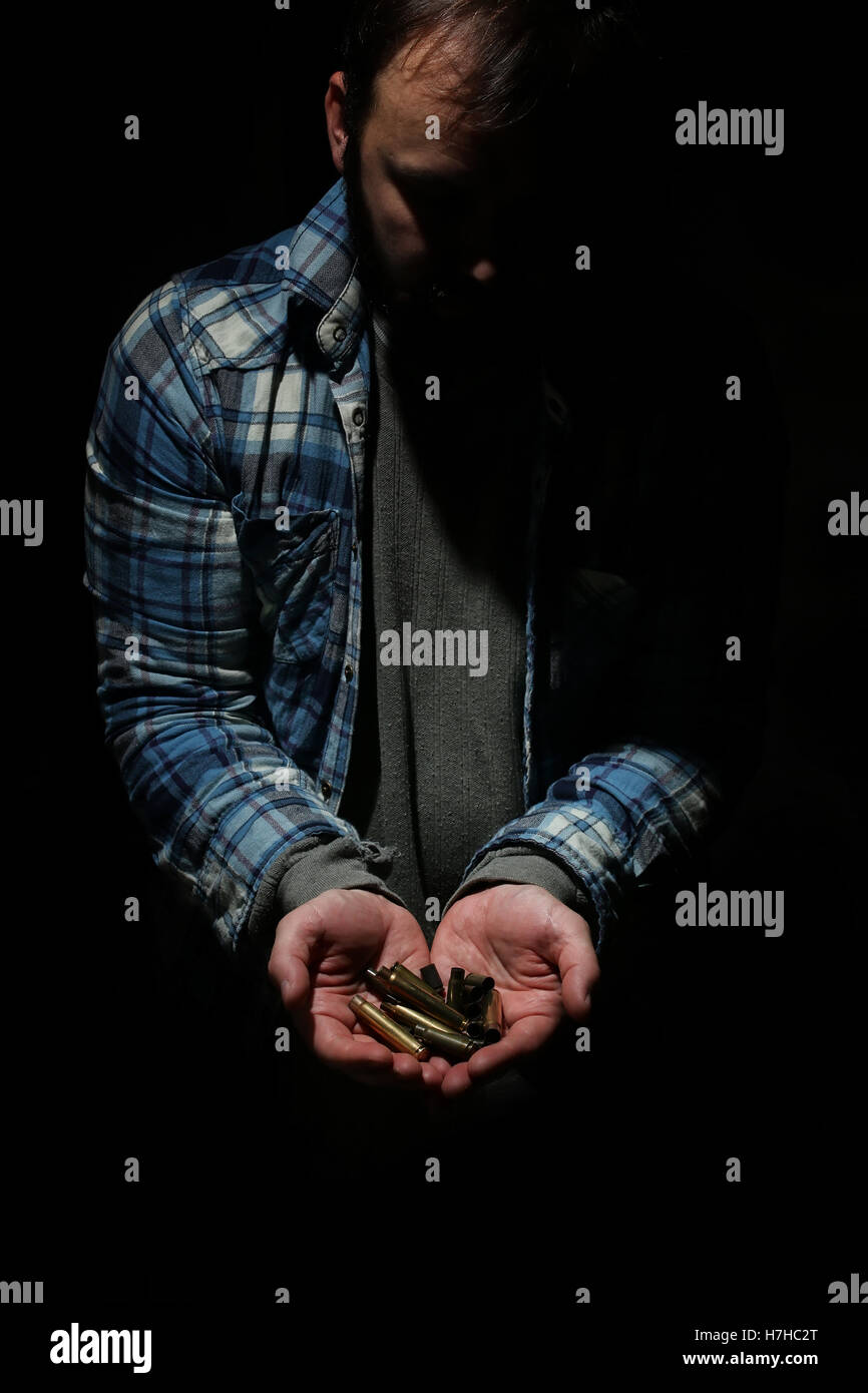 bullet in hands man Stock Photo - Alamy