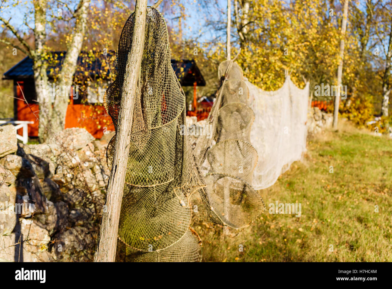 Old fyke and fishnet hung up to dry. Shallow focus on fyke and blurred ...