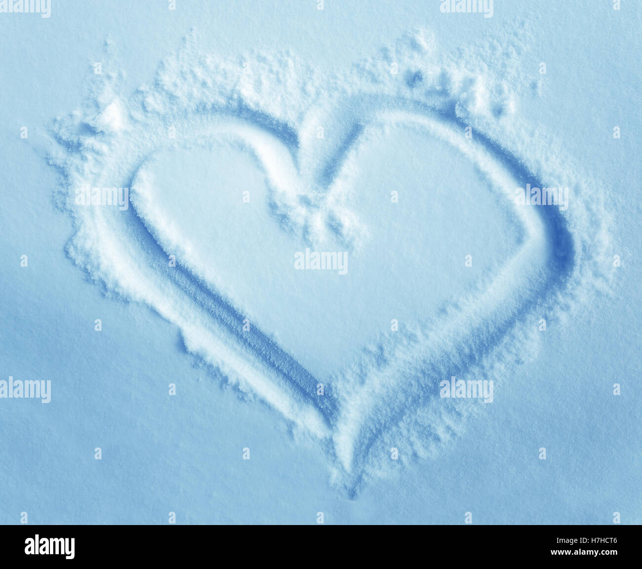 heart in snow, drawing in the snow. Light blue background Stock Photo ...