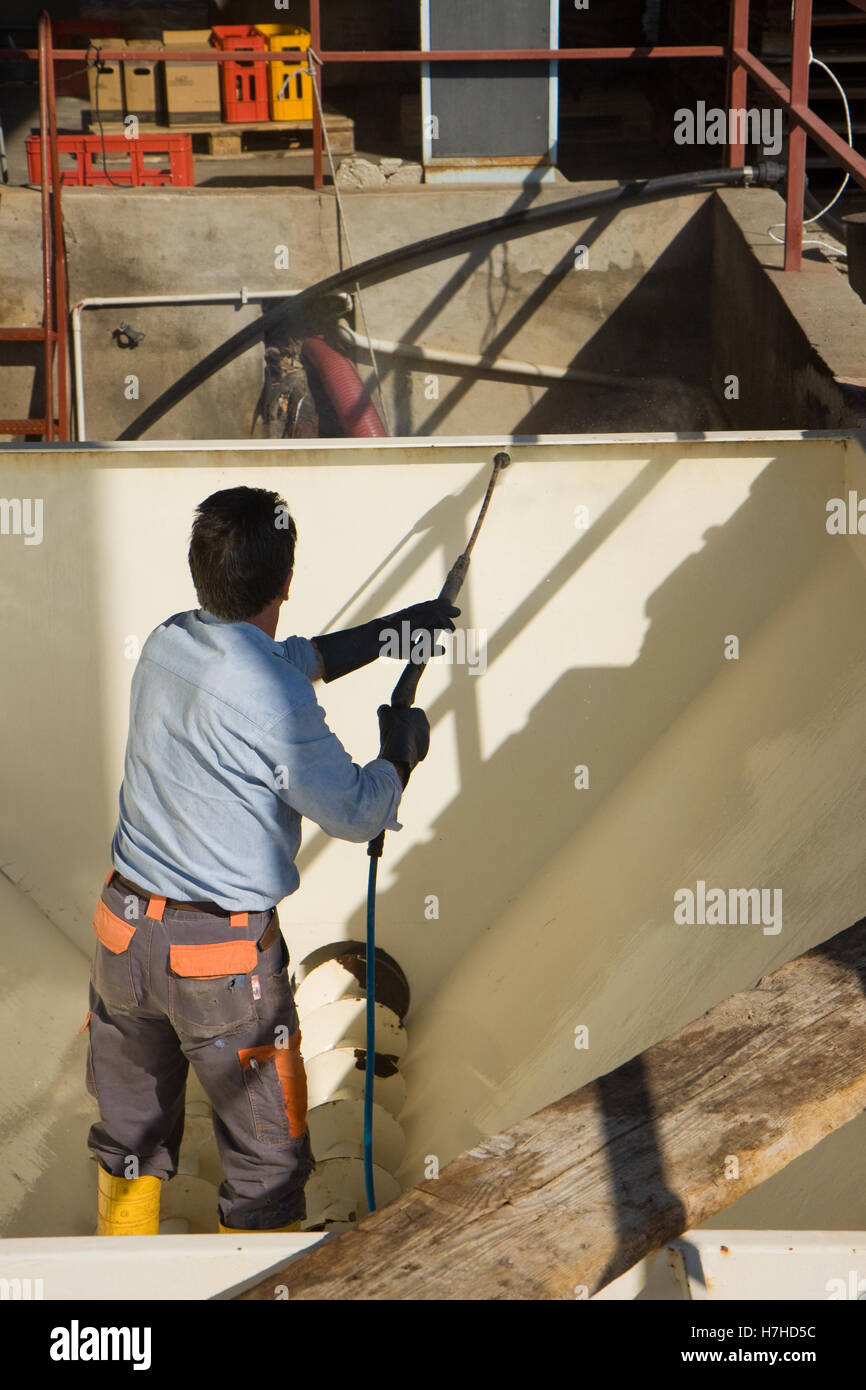 worker cleaning industrial site with a pressure washer Stock Photo - Alamy