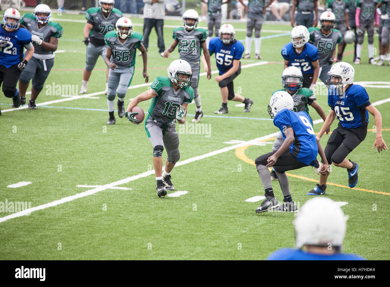 Young teen football game with runner meeting the opposition head on. St ...