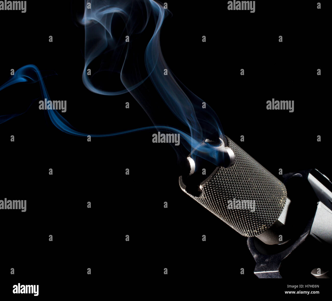 Barrel on a firearm smoking after a shot on a black background Stock ...