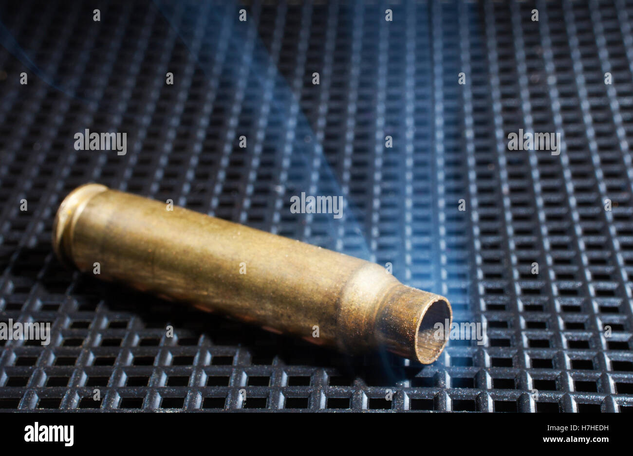 Rifle casing that has been shot and has smoke around Stock Photo - Alamy