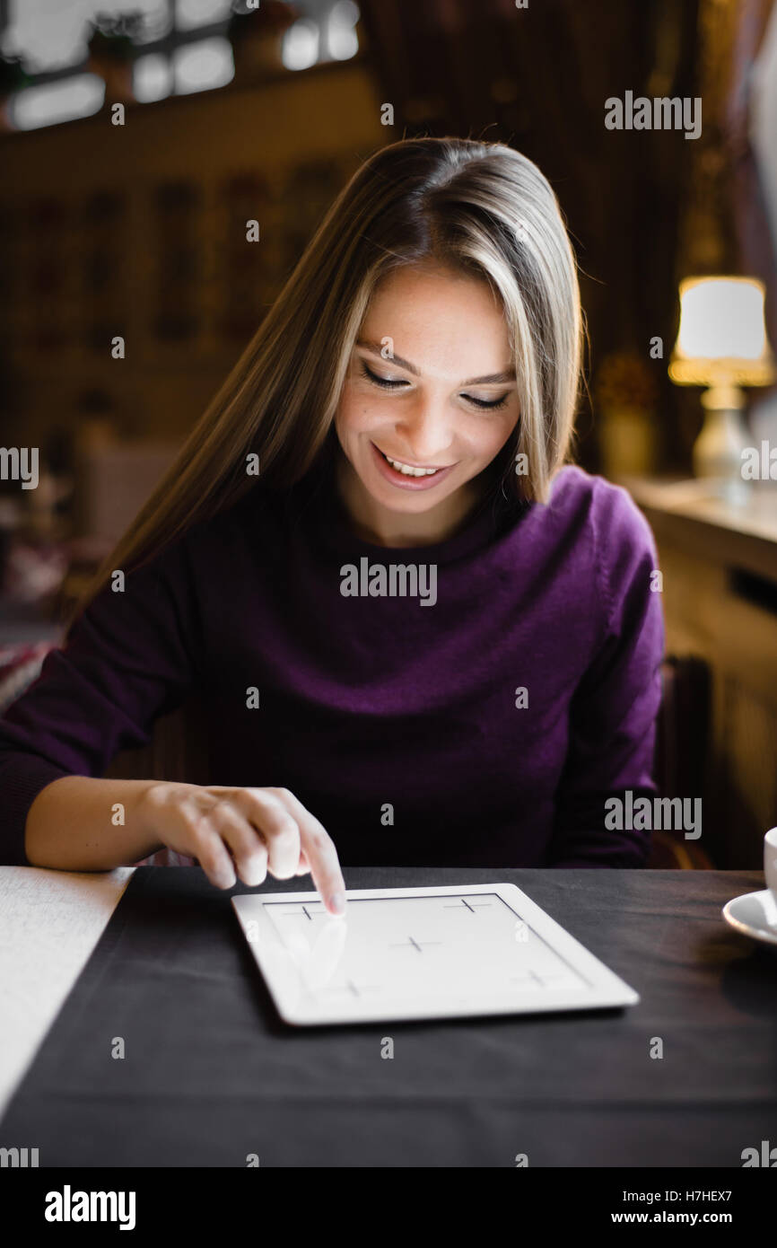 Woman scrolling tablet Stock Photo - Alamy