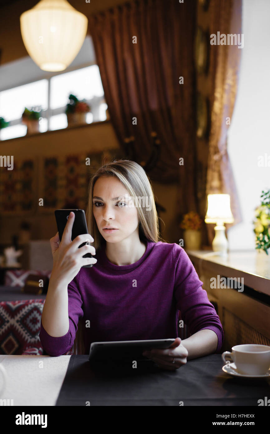Thinking woman with phone Stock Photo - Alamy
