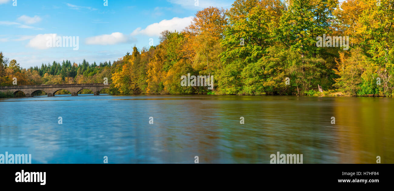 A panoramic view of a lake in Virginia Water in Surrey in fall colors ...