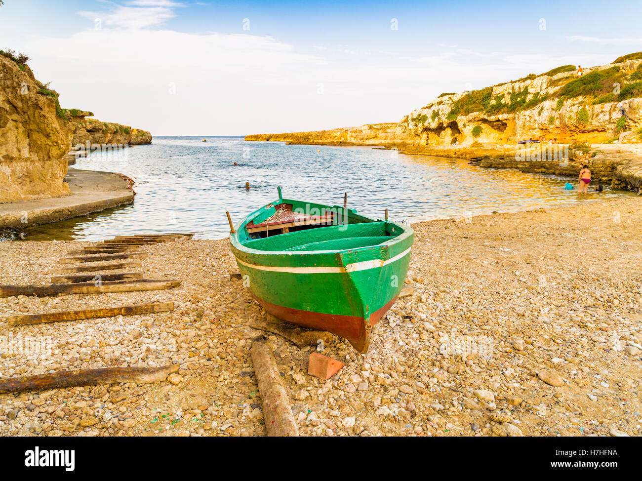 Green rowing boats aground on the beach Stock Photo - Alamy