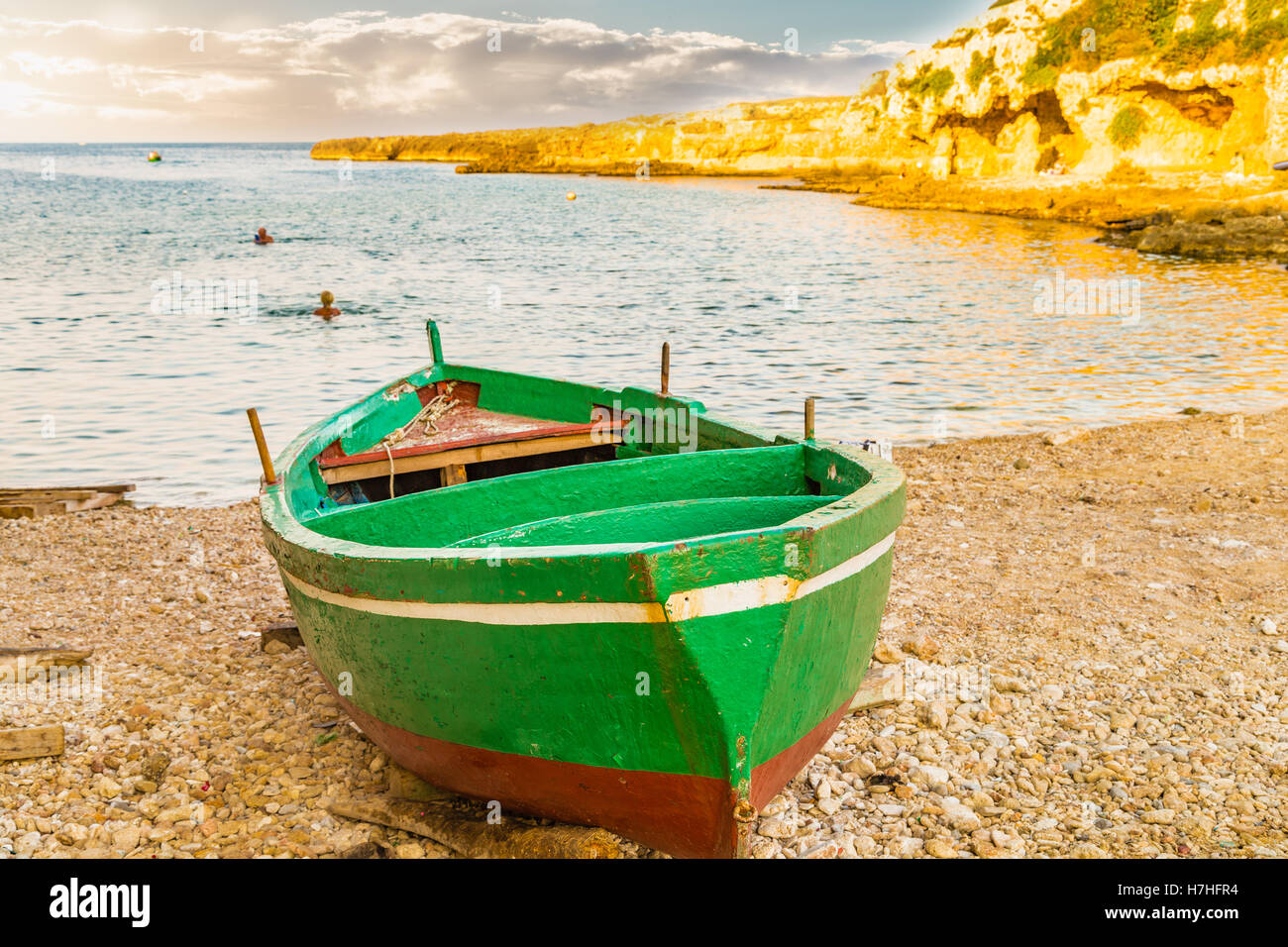 Green rowing boats aground on the beach Stock Photo - Alamy