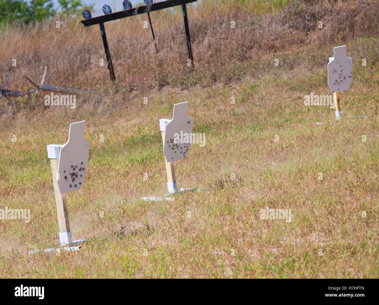 Three shooting targets made of steel with plates behind Stock Photo - Alamy