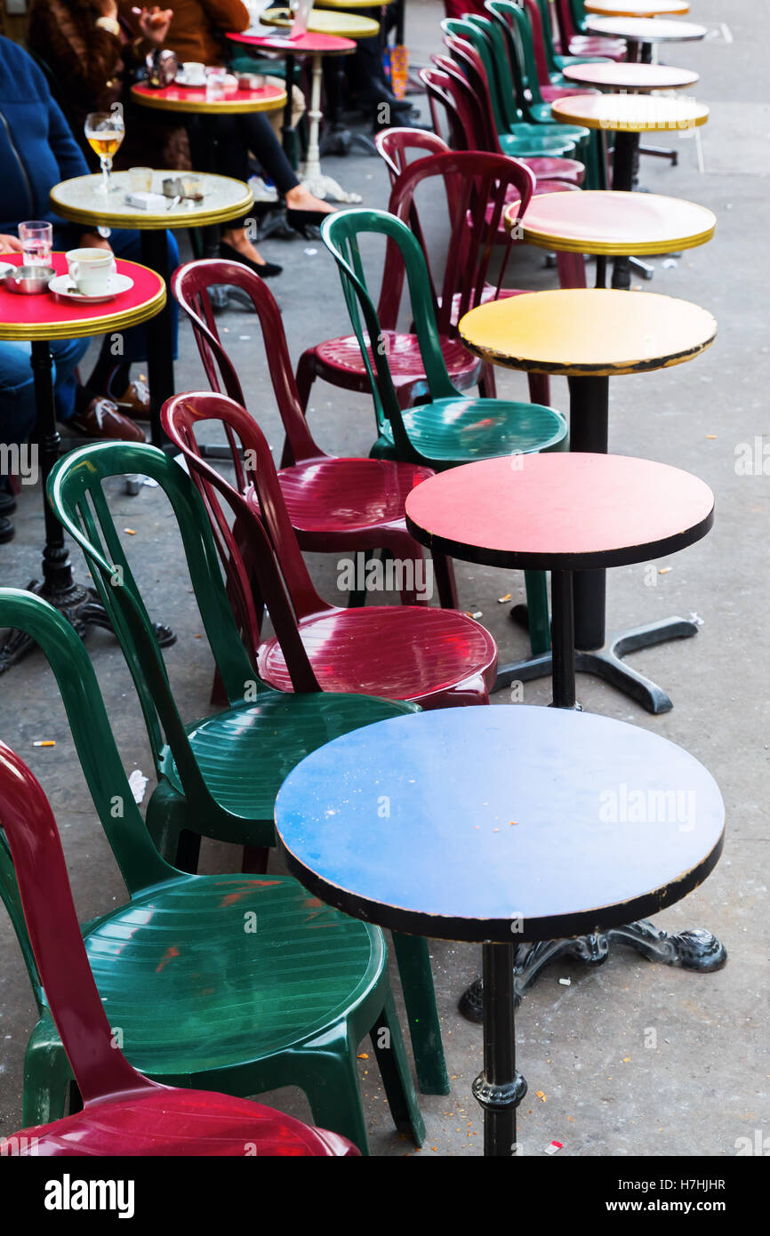 row of colorful tables of a street cafe in Paris, France Stock Photo ...
