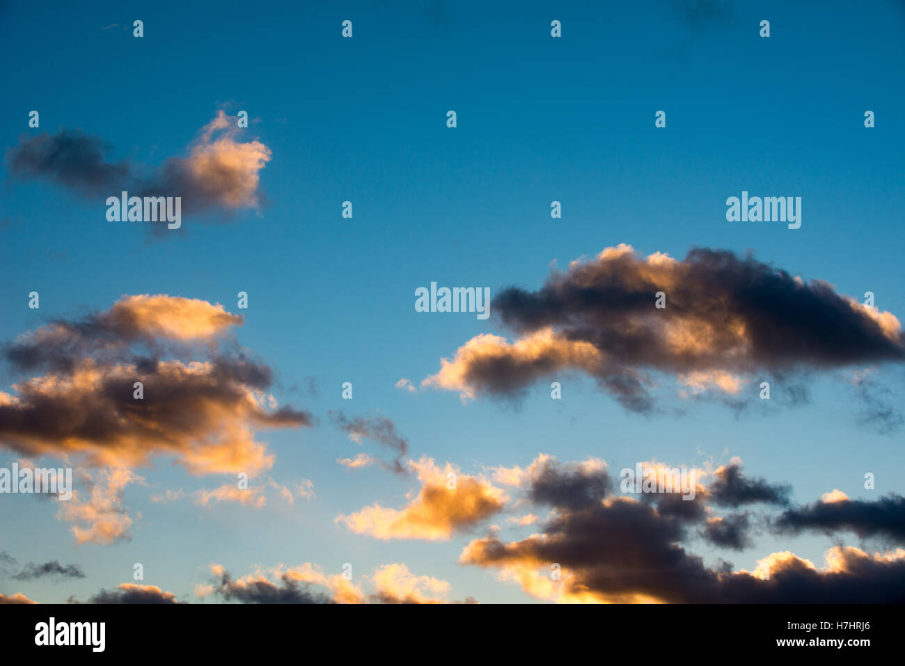 Puffy and colorful sunset clouds Stock Photo - Alamy
