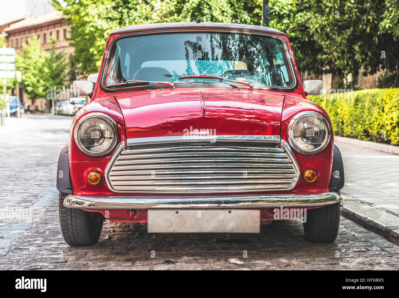 Vintage small red car on the street Stock Photo - Alamy