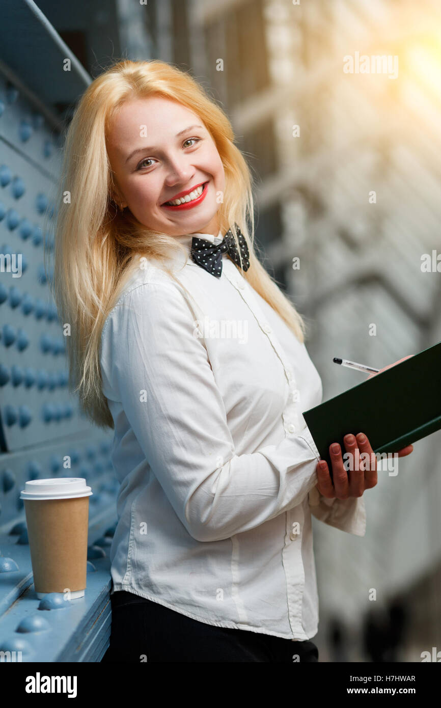 Laughing ginger woman with red lips holding note-book Stock Photo - Alamy