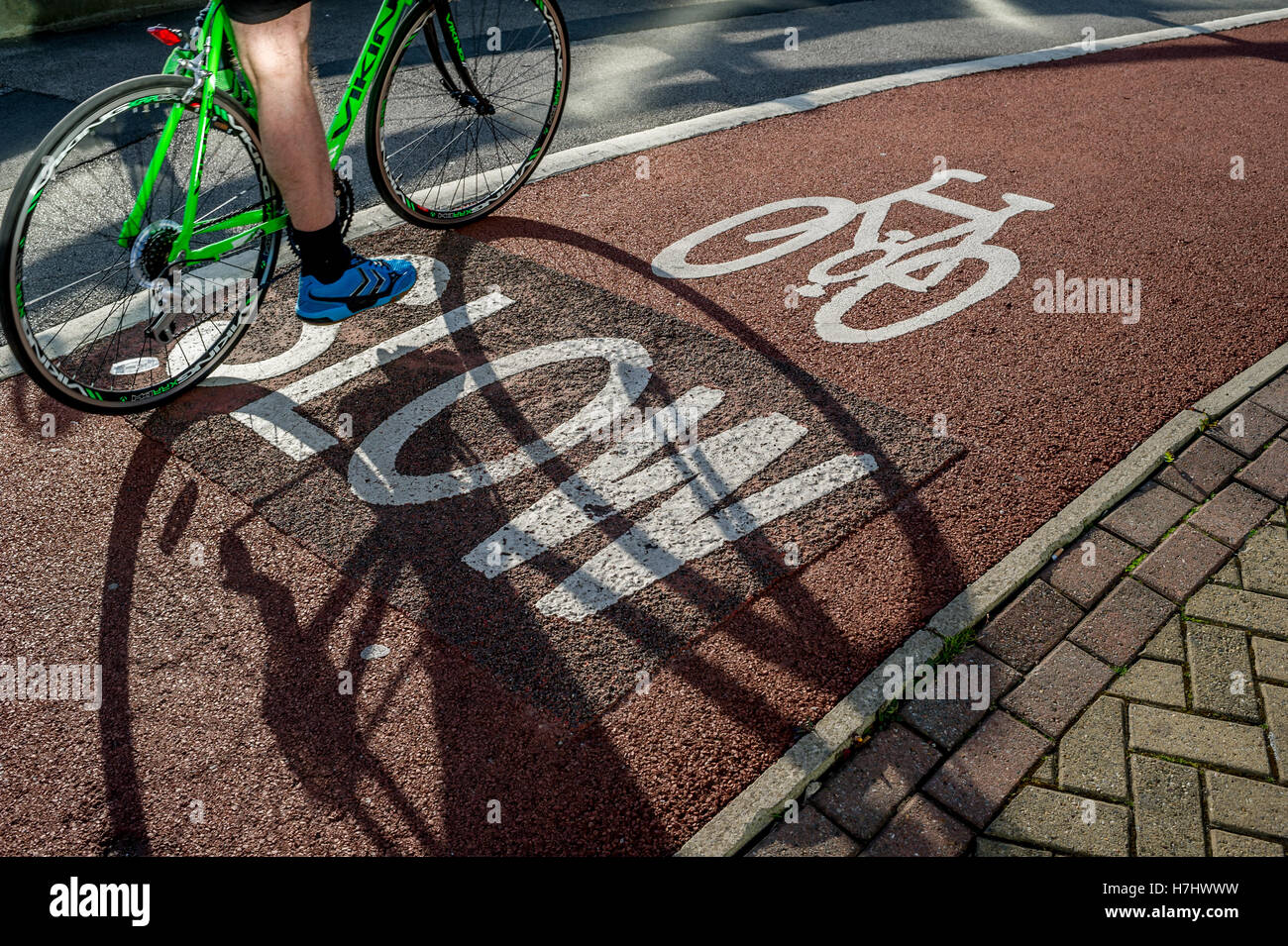 Cyclist on a cycle lane displaying 'Slow' sign, Sheffield Stock Photo ...