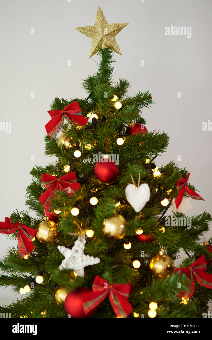 Golden star on the top of the Christmas tree Stock Photo - Alamy