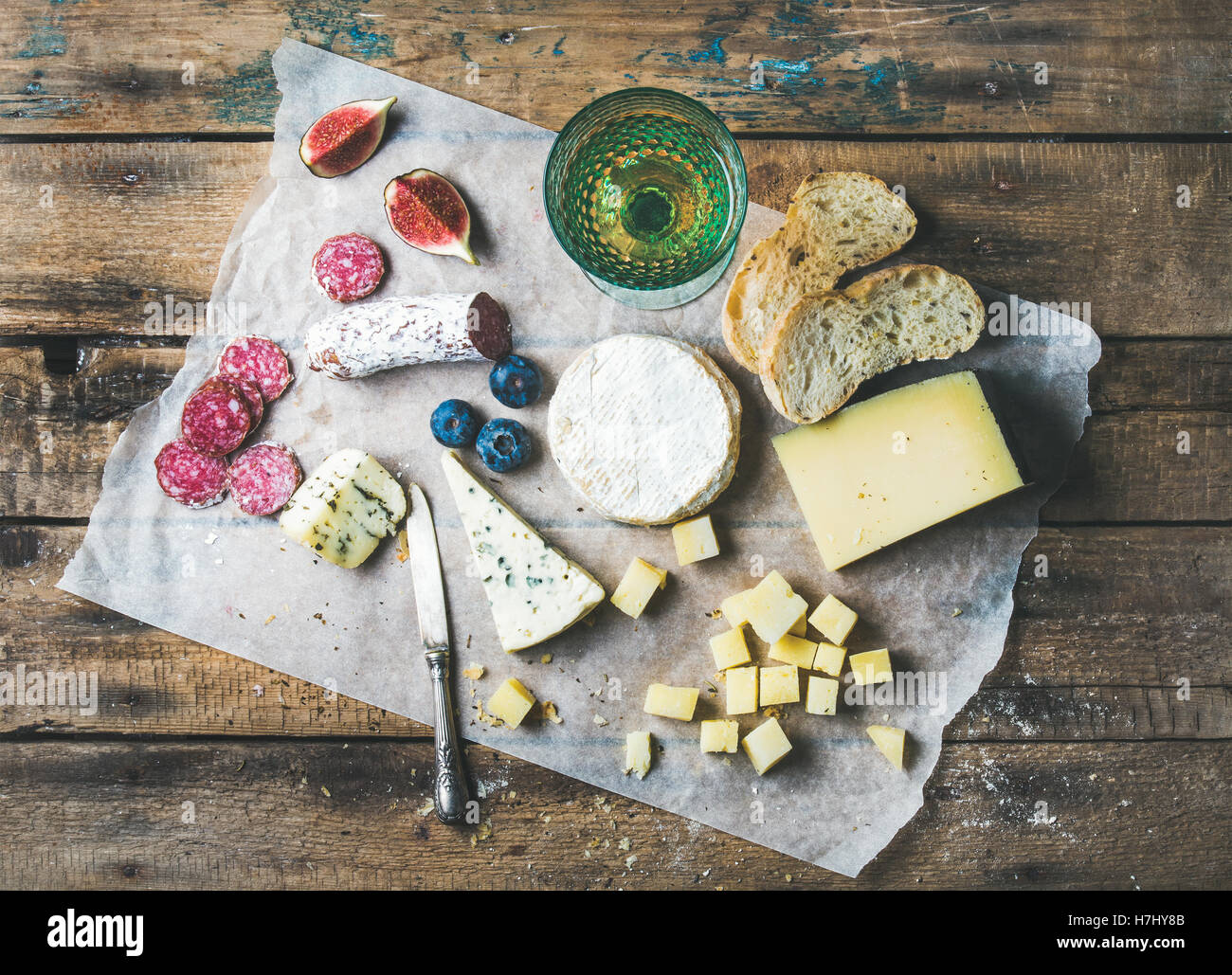 Glass of rose wine, cheese, cured sausage, fig, blueberry, bread Stock ...