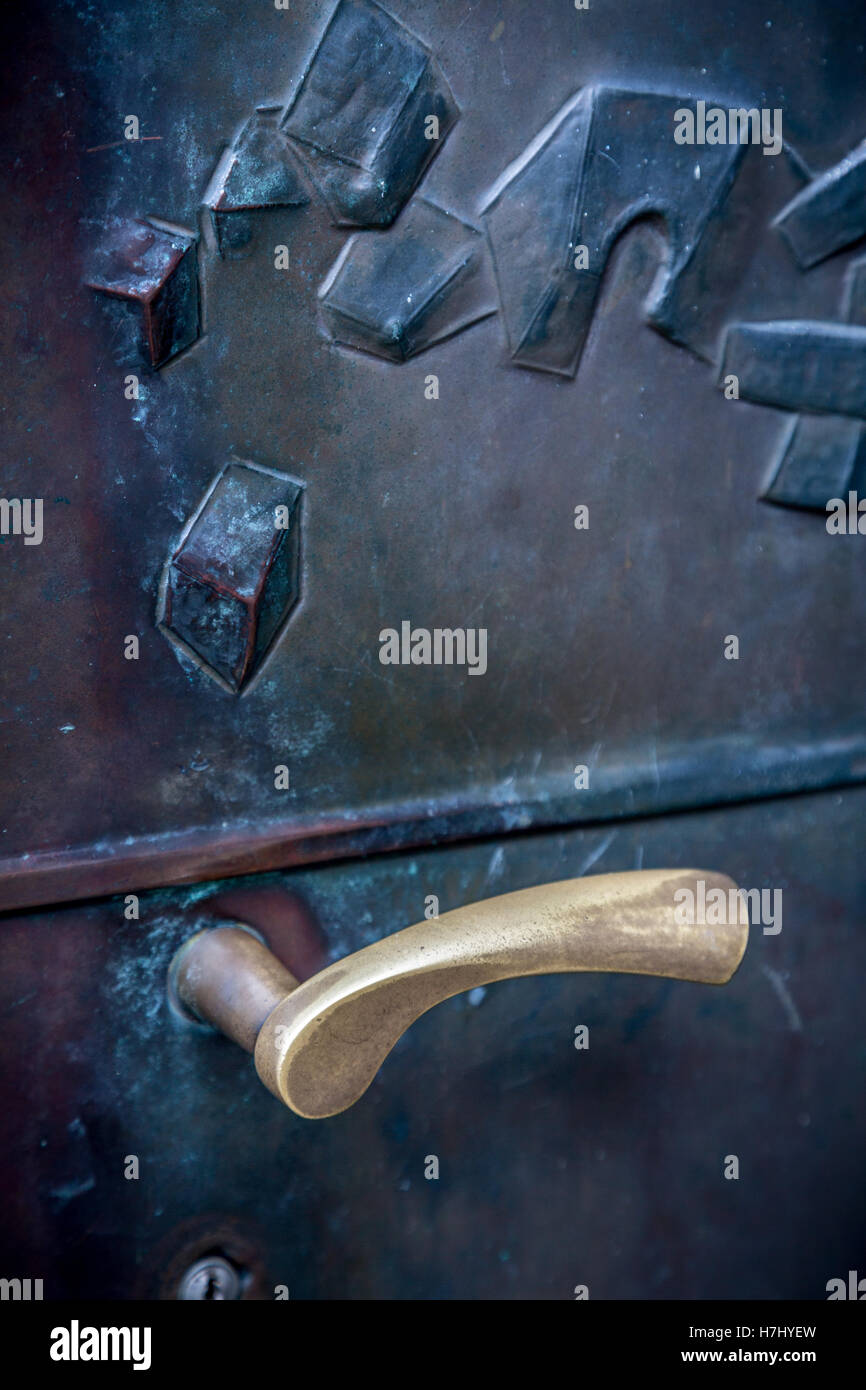 Old door handle in heavy metal door Stock Photo - Alamy