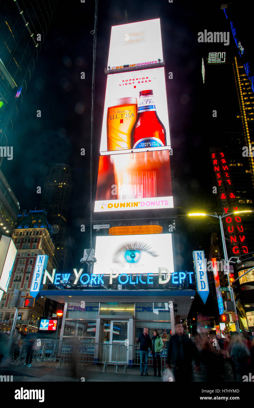 Night in Times Square, New York City. NYPD Police station below huge ...