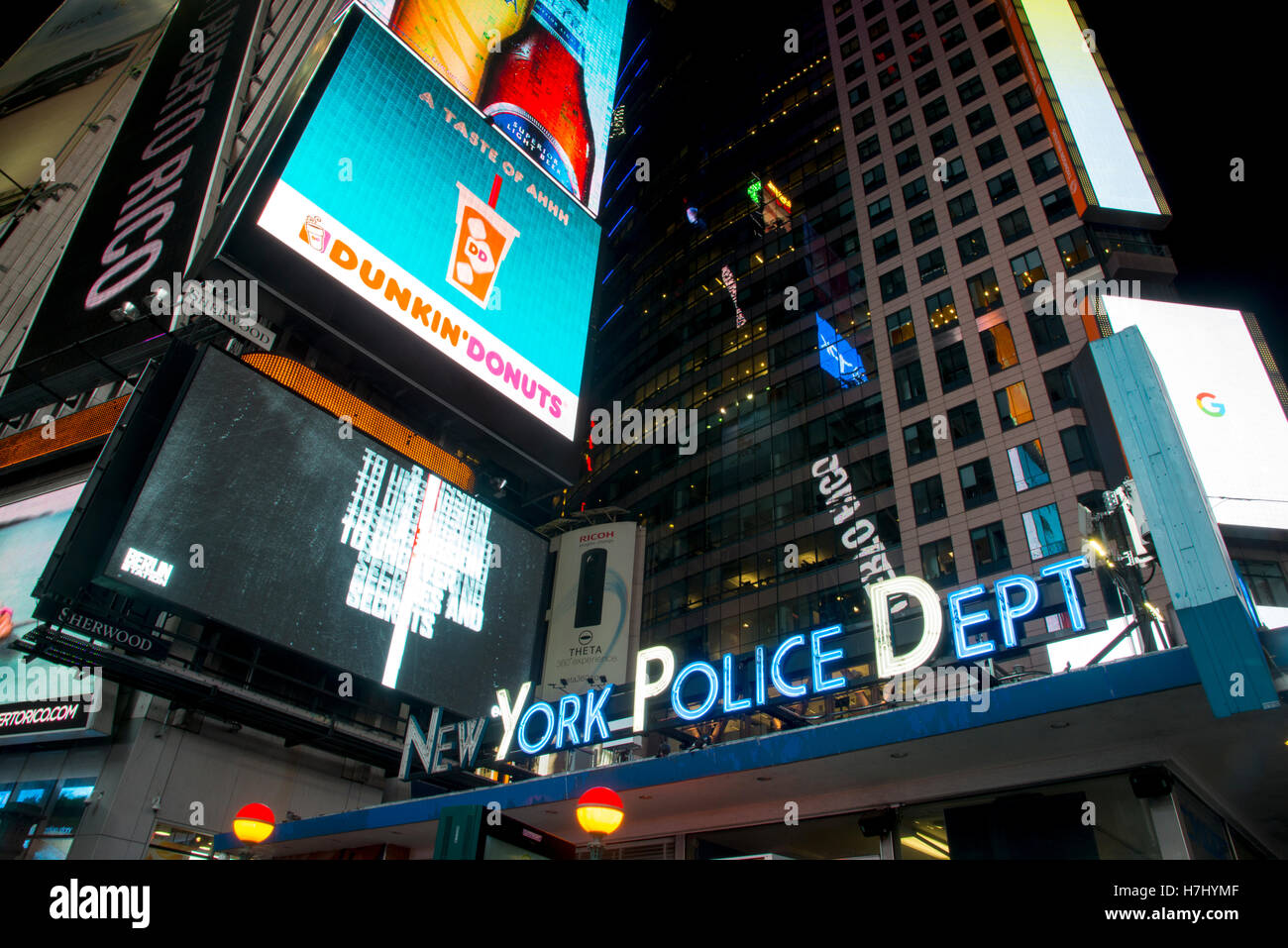 Night in Times Square, New York City. NYPD Police station dwarfed by ...