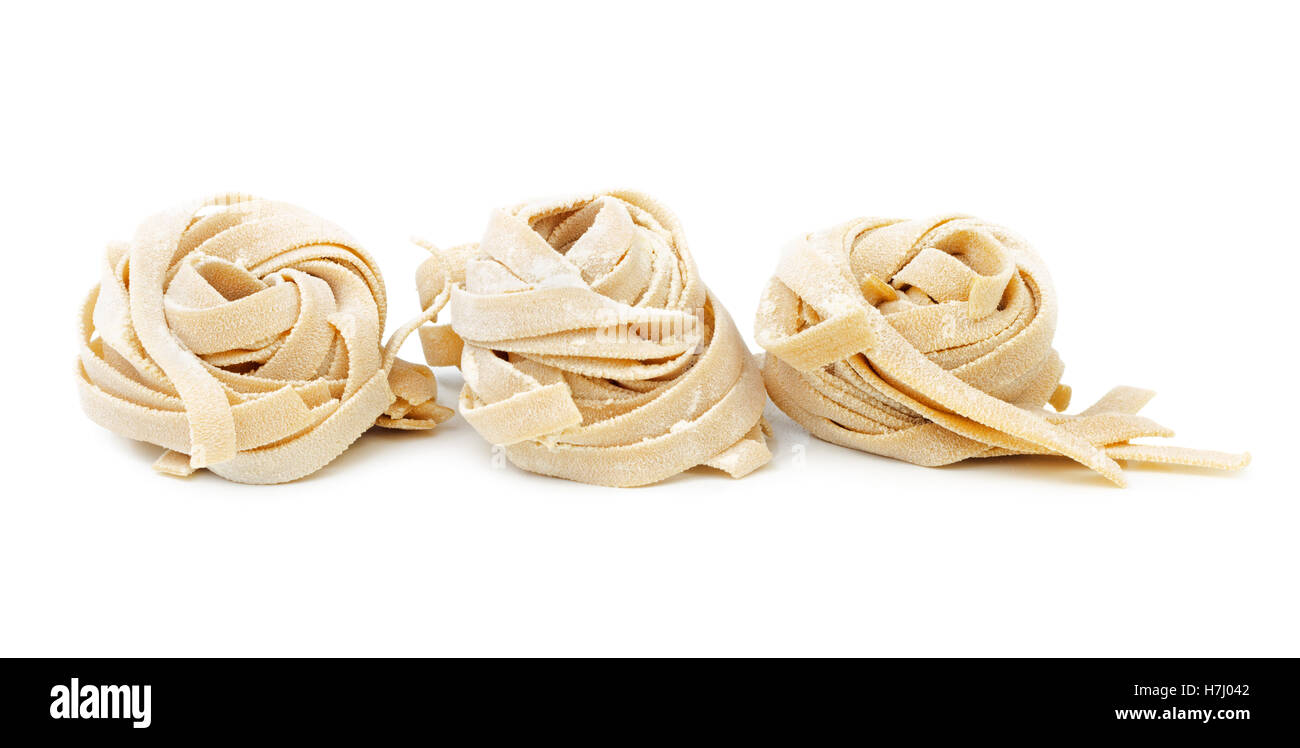 Homemade rolled traditional italian pasta tagliatelle in row isolated ...