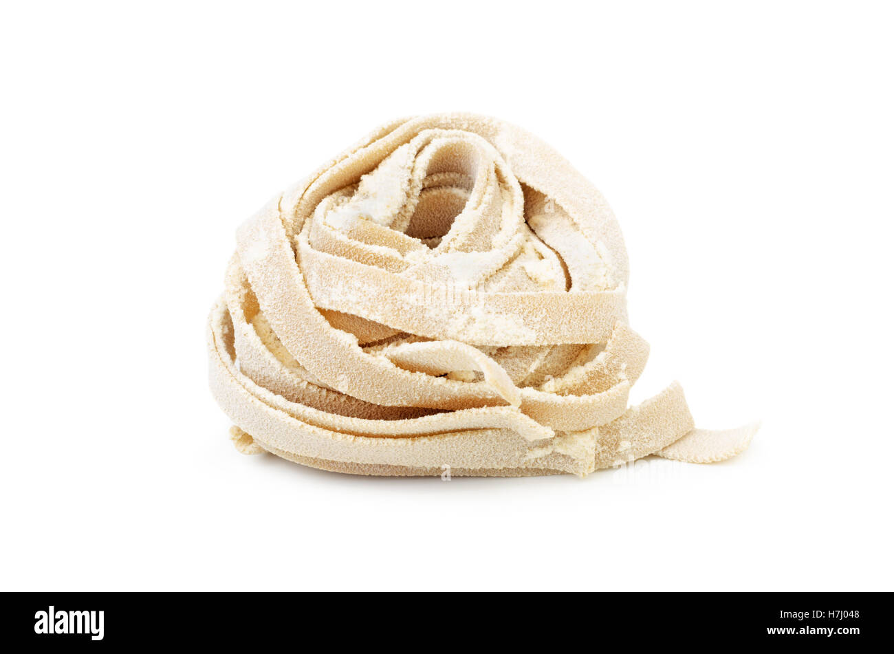 Single dry homemade rolled traditional italian pasta isolated on white ...