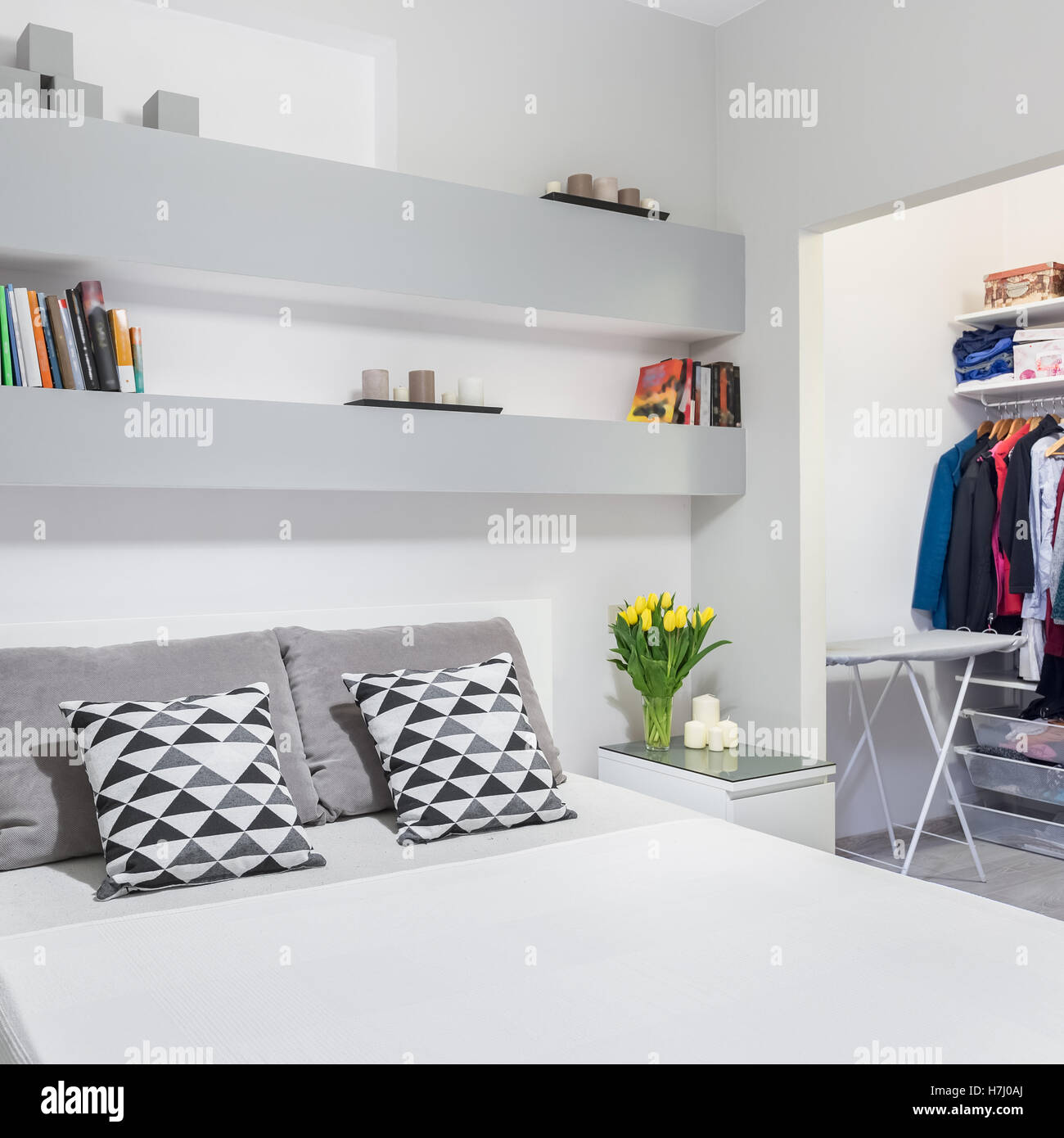 Functional bedroom with walk-in wardrobe and double bed Stock Photo - Alamy