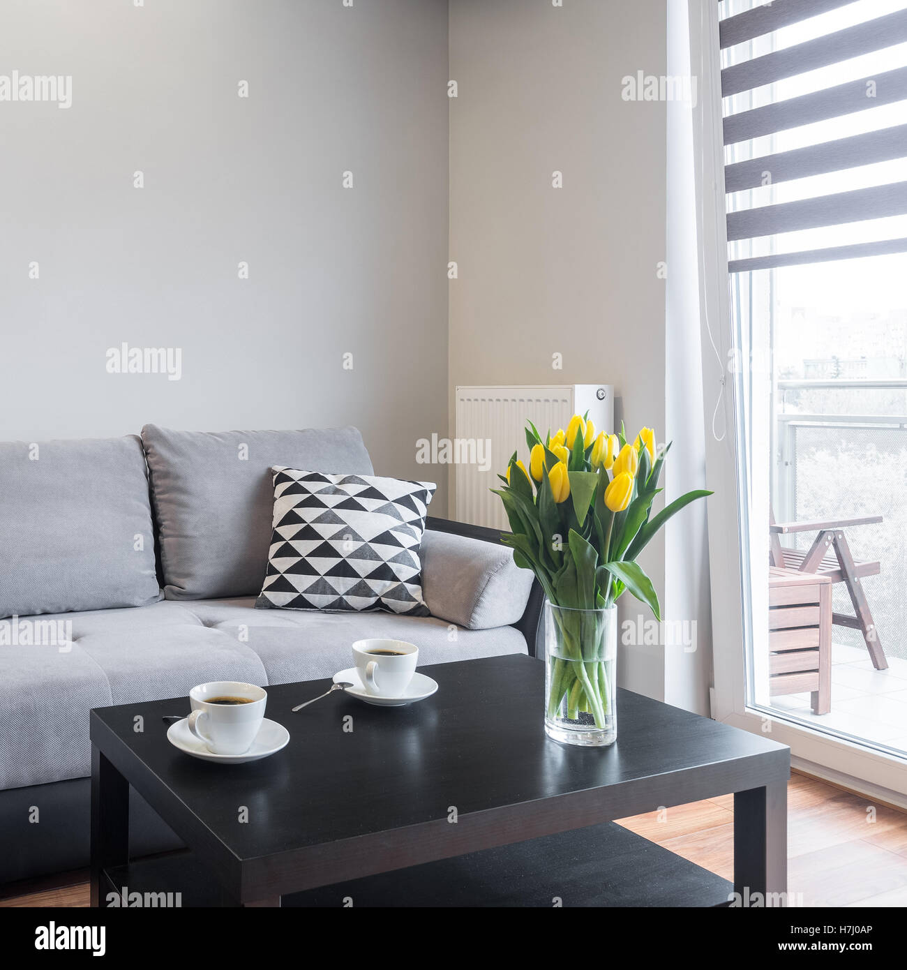 Light living room with big window, coffee table and comfortable sofa ...