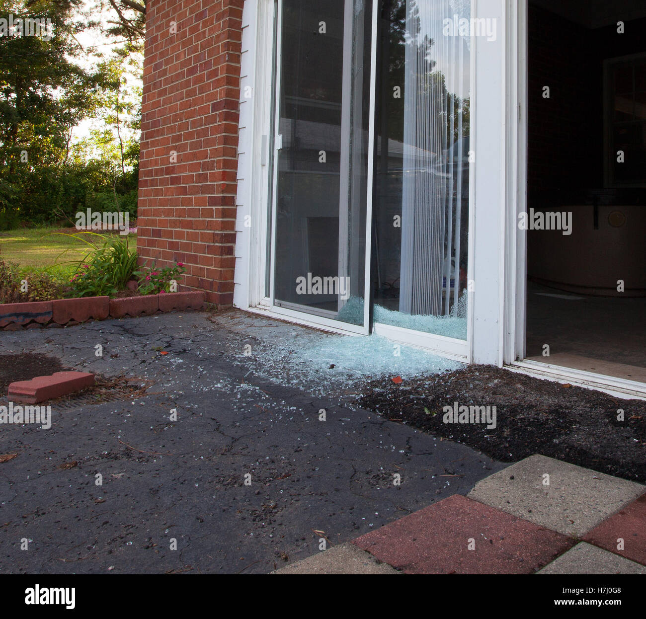 Shattered sliding glass window the morning after a home invasion Stock ...