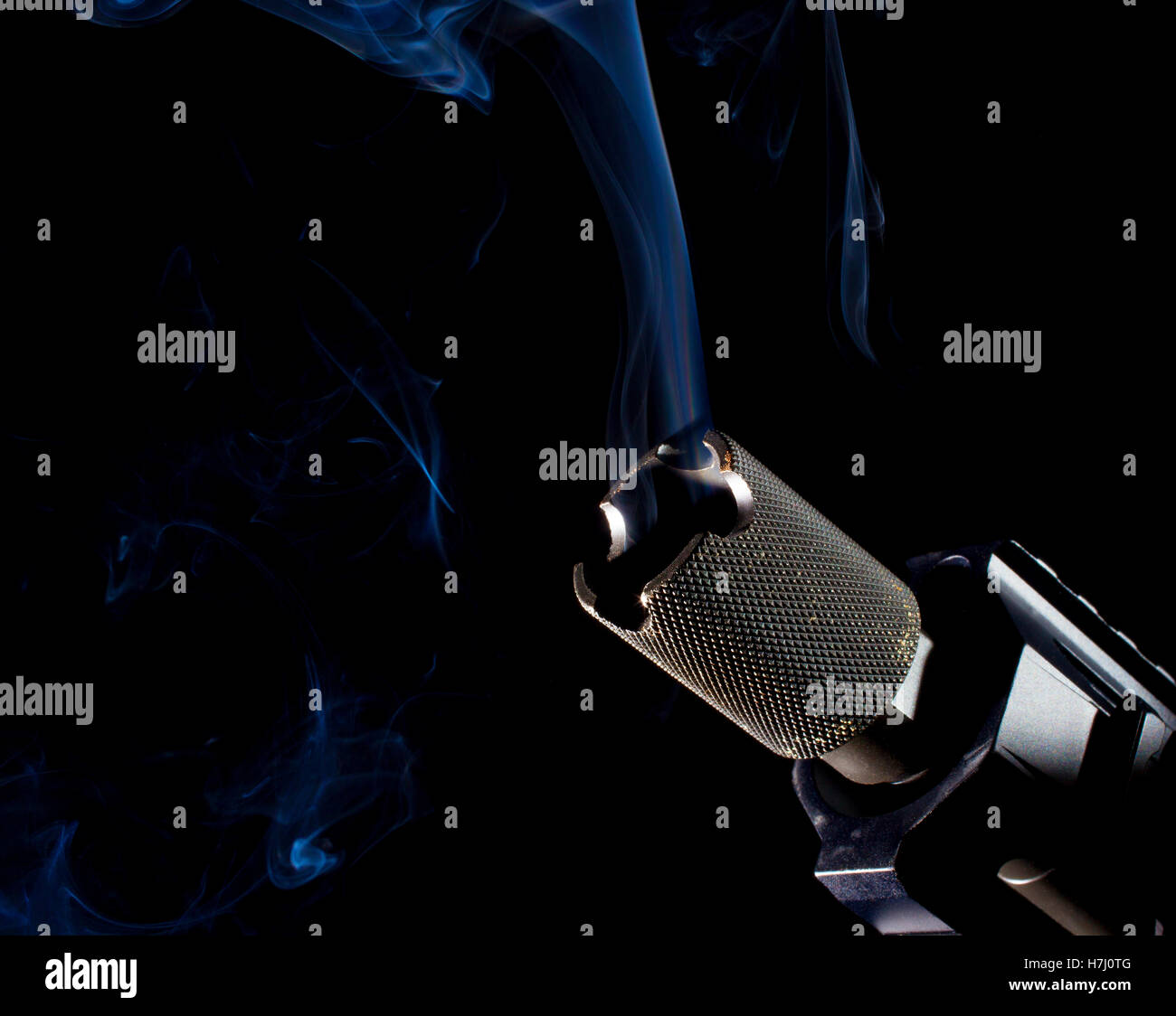 Blue smoke around a gun after a shot on a black background Stock Photo ...