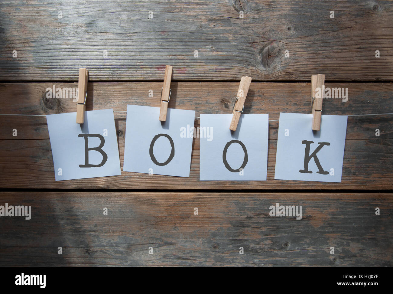 Notes spelling book hanging on washing line Stock Photo - Alamy