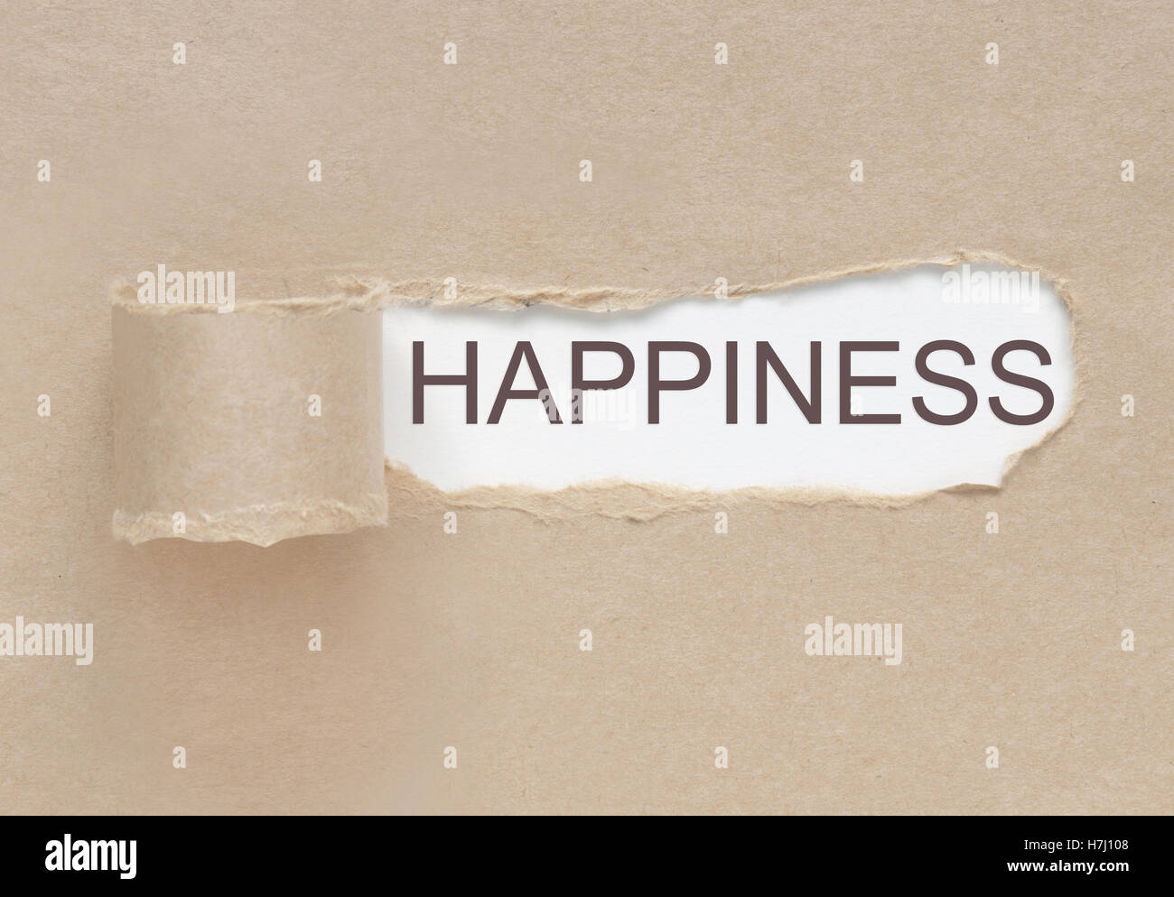 Torn paper revealing the word happiness underneath Stock Photo - Alamy