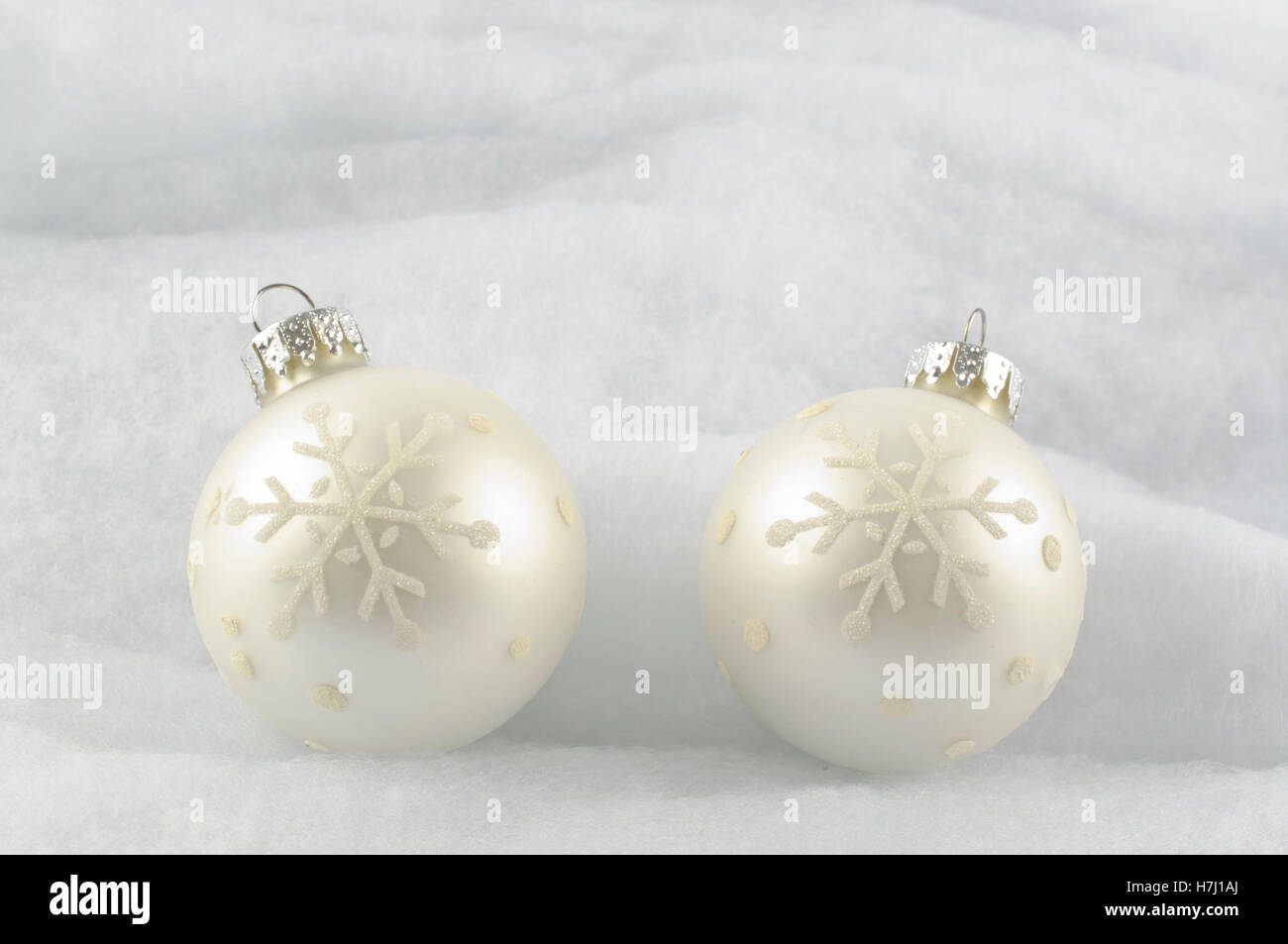 Christmas Baubles on snow white background Stock Photo - Alamy