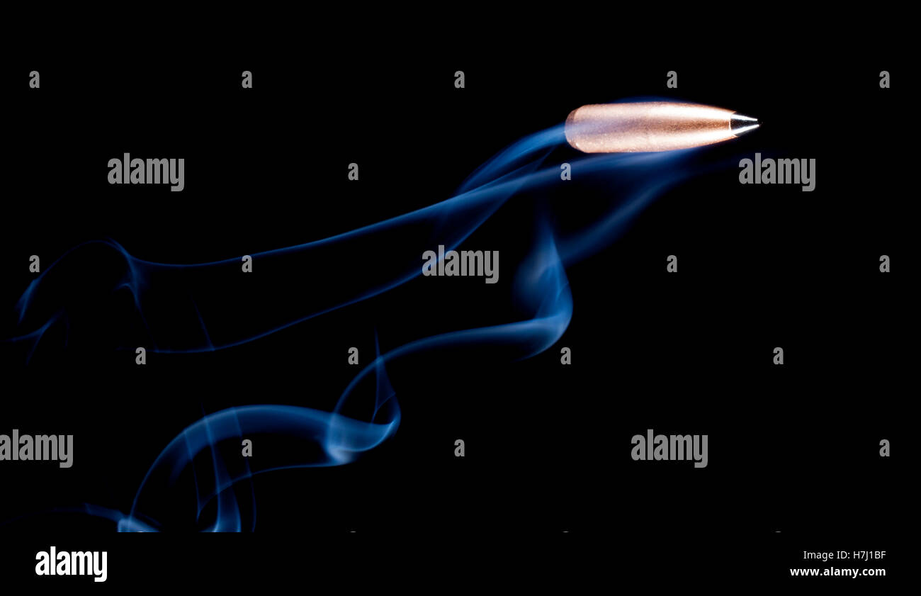 Copper colored bullet with a polymer tip and lead core with smoke Stock ...