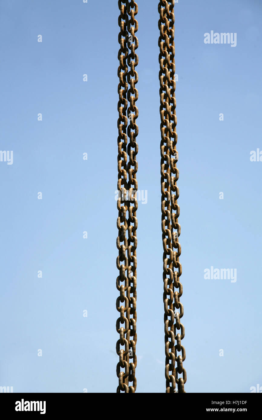 Long metal chains hanging vertically against blue sky Stock Photo - Alamy
