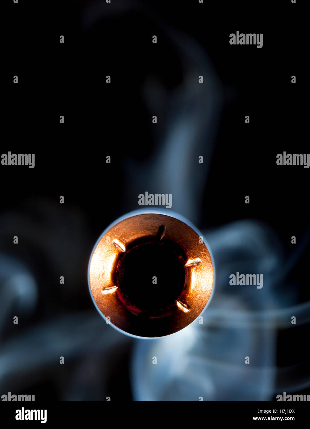Copper jacketed bullet with a hollow point and smoke behind Stock Photo ...