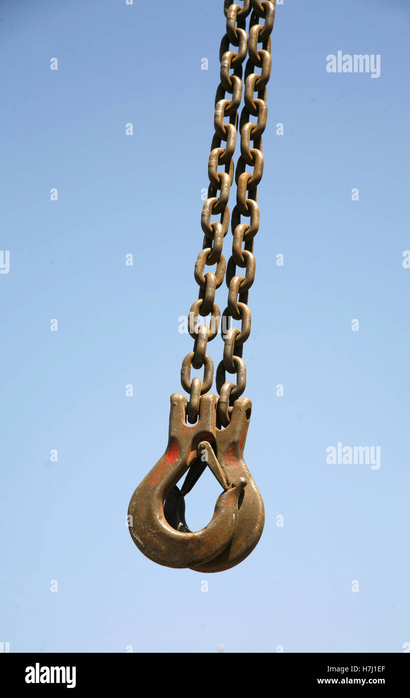 Long chains with hooks hanging vertically against blue sky Stock Photo ...
