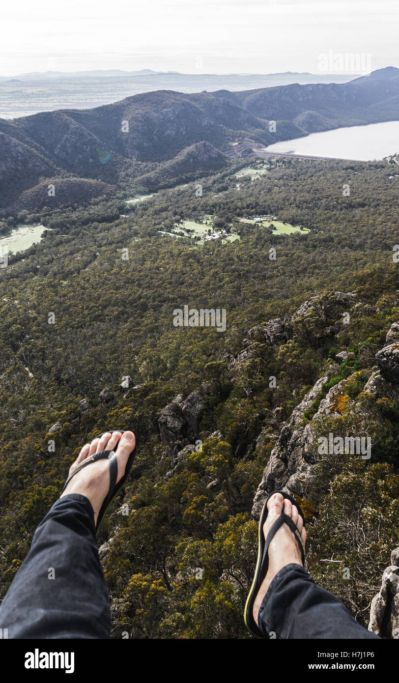 Legs hanging over cliff in the Grampians National Park, Victoria ...