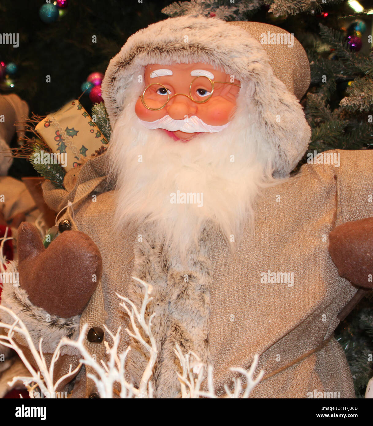 Santa Clause wearing the traditional brown costume with a jolly face, a ...