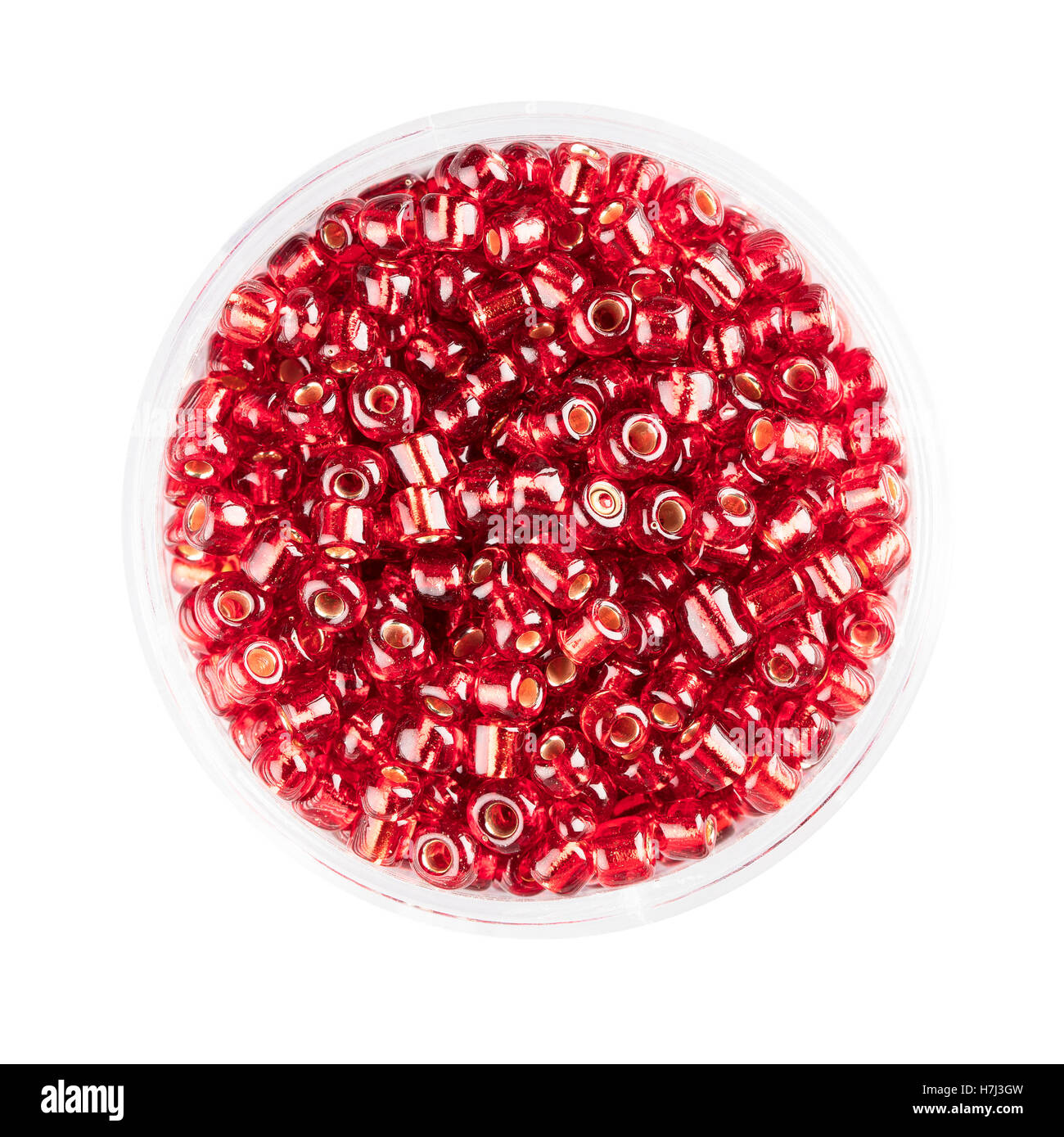 Small container of glass seed beads isolated on white background ...