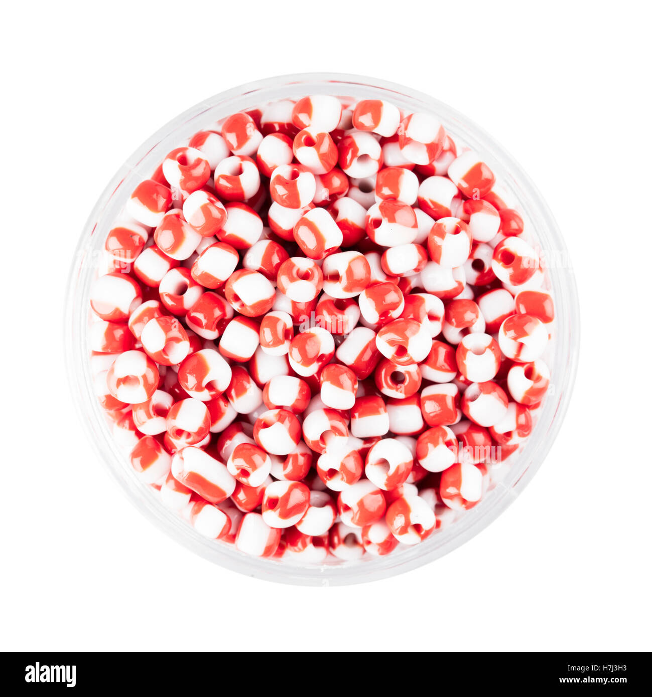 Small container of glass seed beads isolated on white background ...