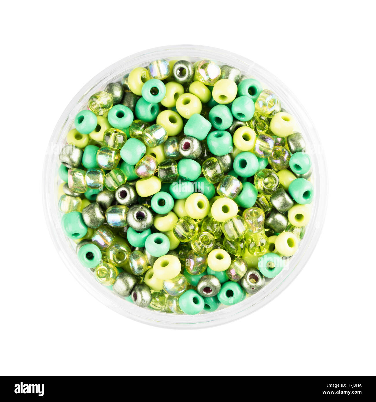 Small container of glass seed beads isolated on white background ...