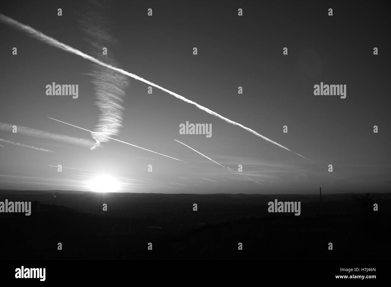 Jet contrails over the sunset black and white BW Stock Photo - Alamy