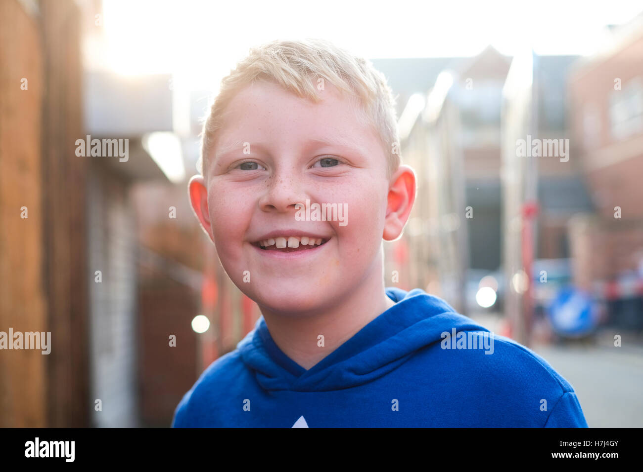 Outdoor photo of smiling boy aged 7 Stock Photo - Alamy