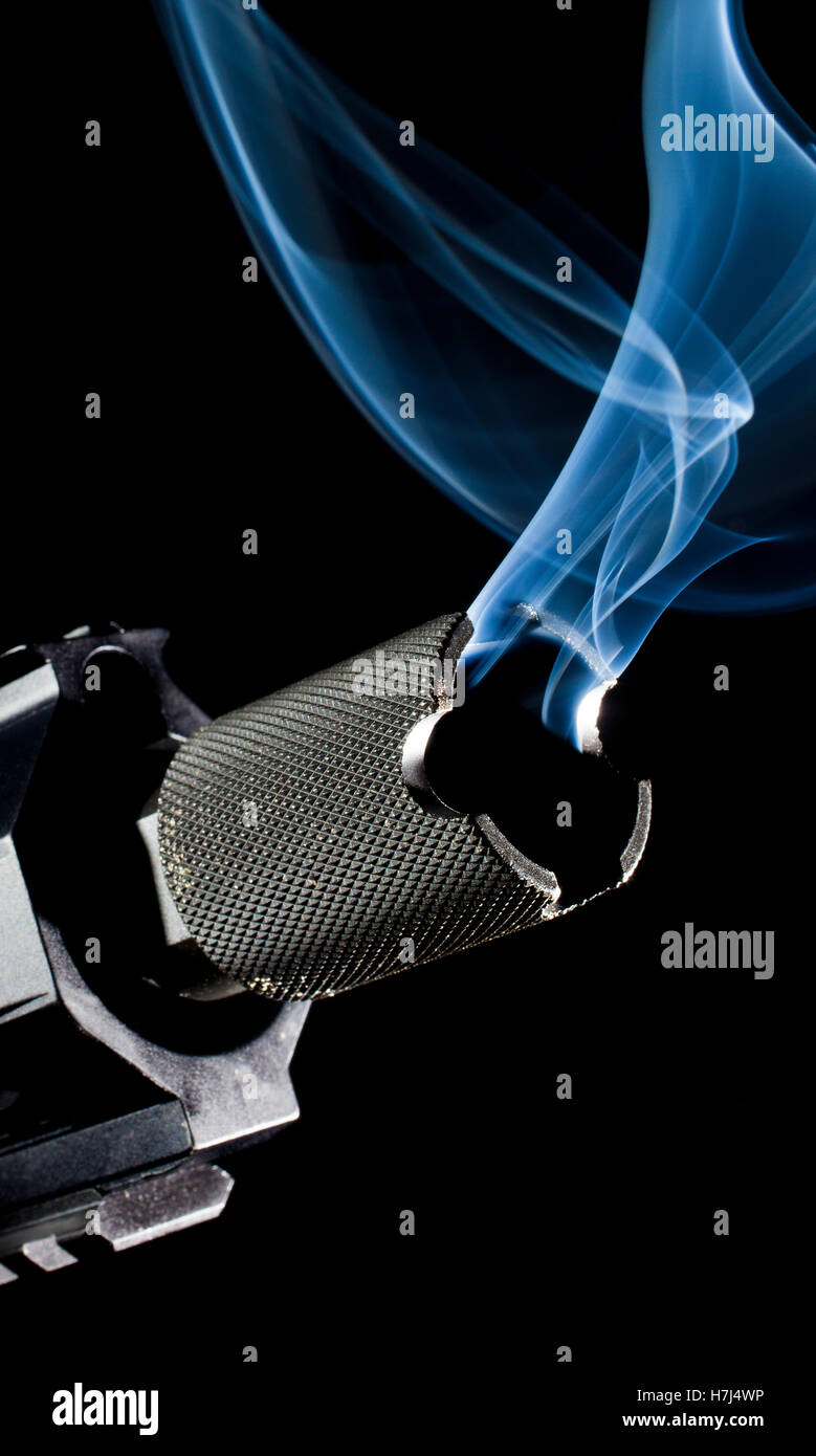 Muzzle side of the barrel on an assault rifle smoking Stock Photo - Alamy