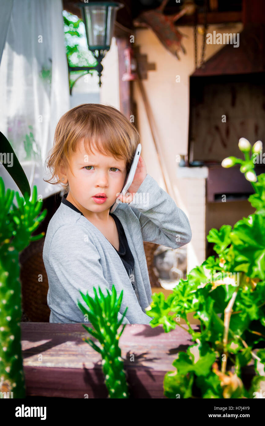 cute little girl talking on the phone. Child with mobile phone, angry ...