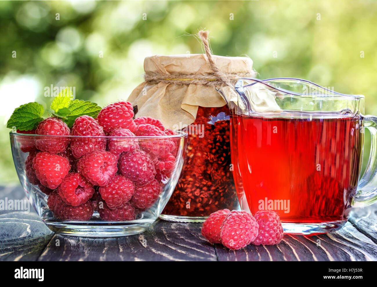Raspberry jam,raspberry juice and fresh raspberry on a rustic wooden ...