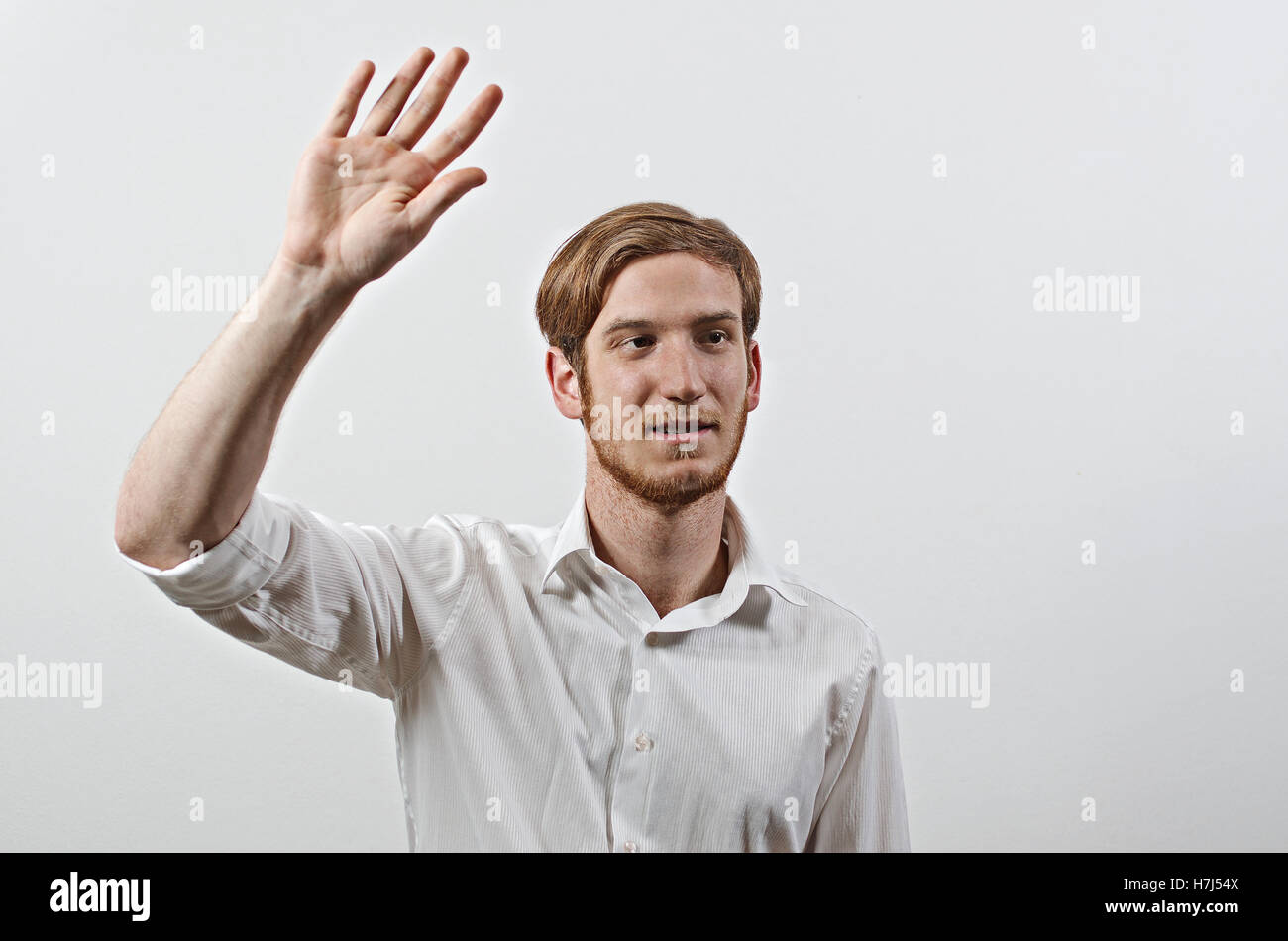 Young Adult Male in White Shirt Gesturing, Waving His Hand Stock Photo ...