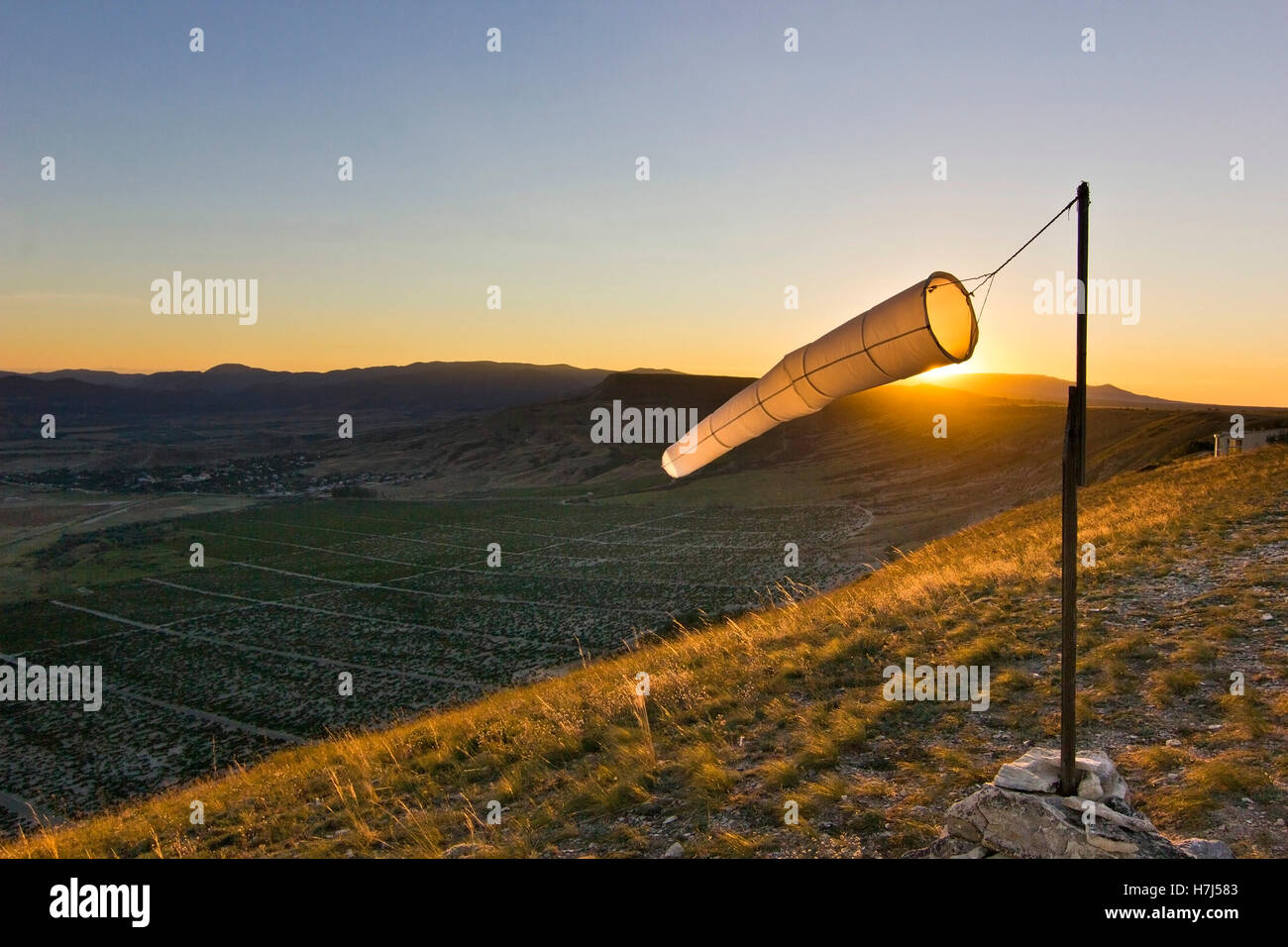paraglider white windsock at sunset in mountains against sun Stock ...